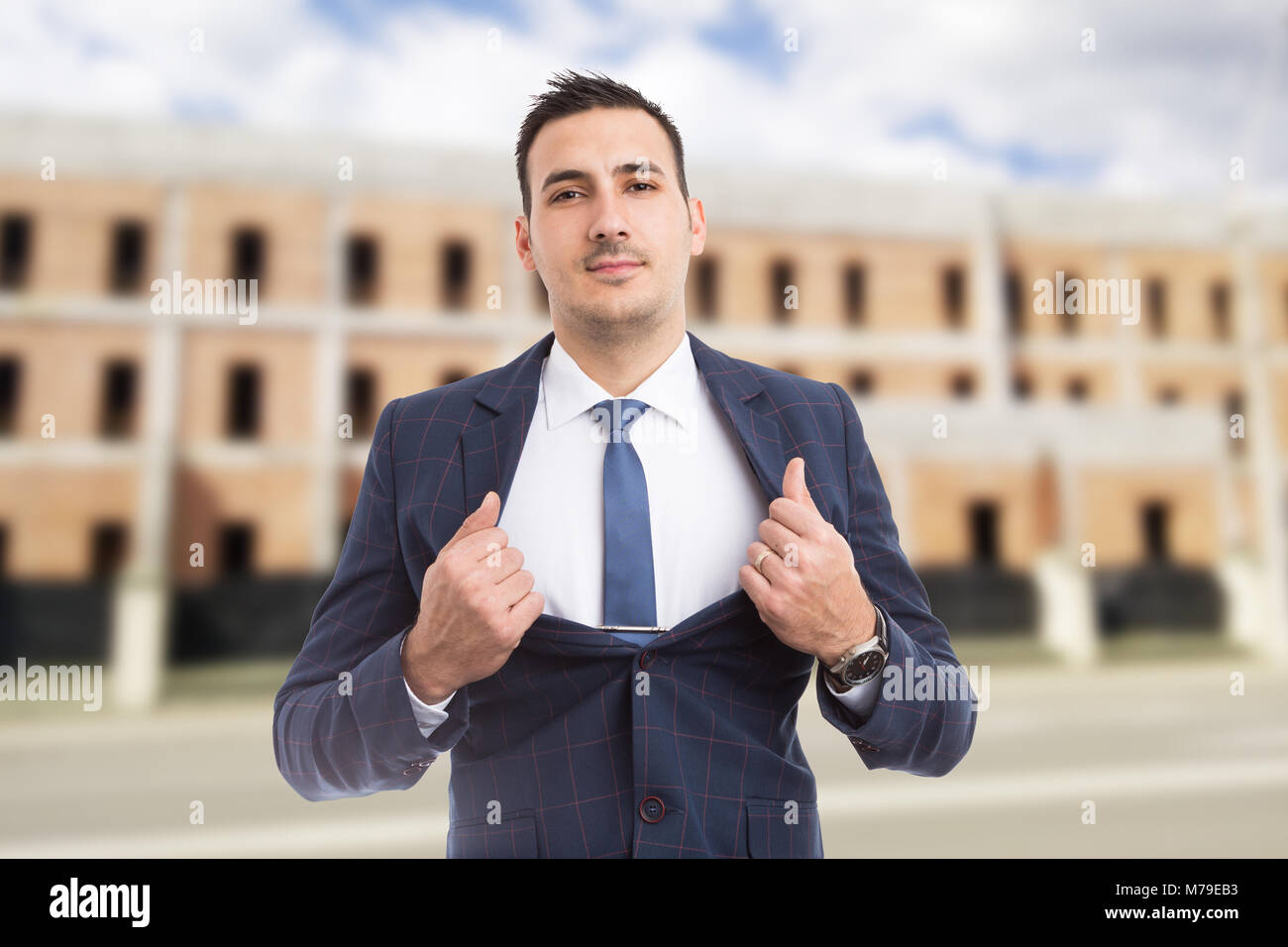 Real estate agent manager showing superhero chest as power and success ...