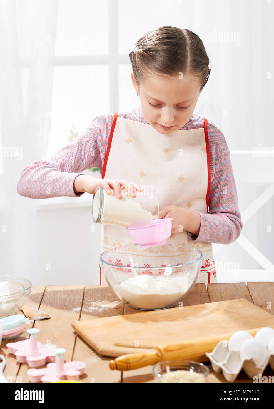 Cooking at home, girl in kitchen, making dough, healthy food concept ...