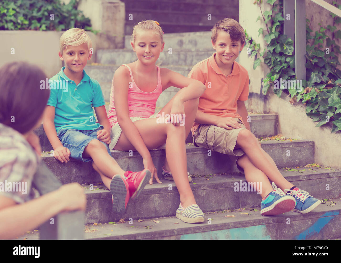 Portrait of positive french children which are walking in the park ...