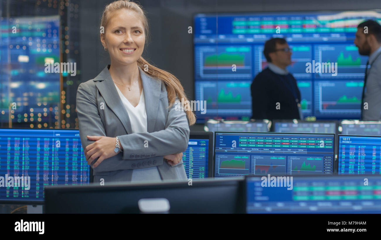 Successful Female Stock Trader Crosses Arms and Smiles at the Camera ...