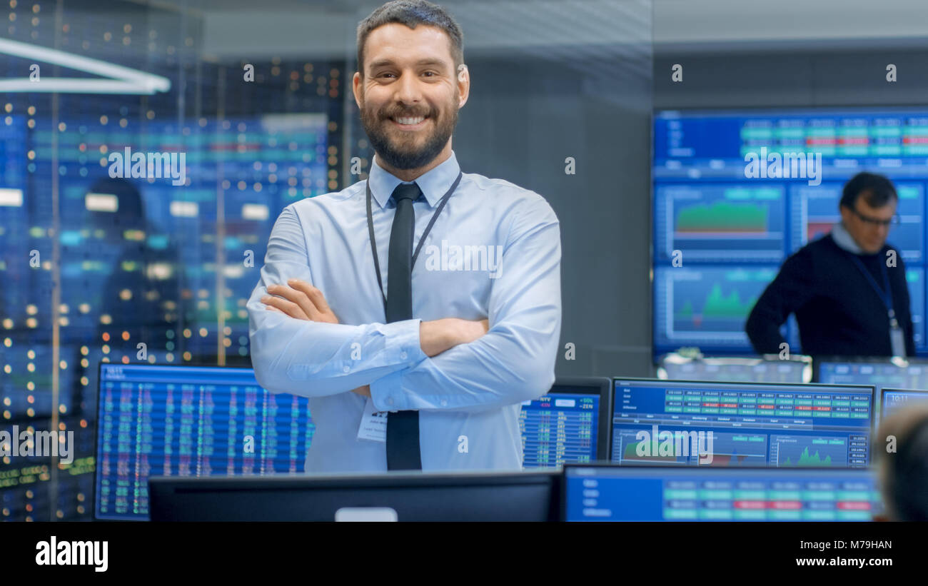 Successful Male Stock Trader Crosses Arms and Smiles at the Camera. In ...