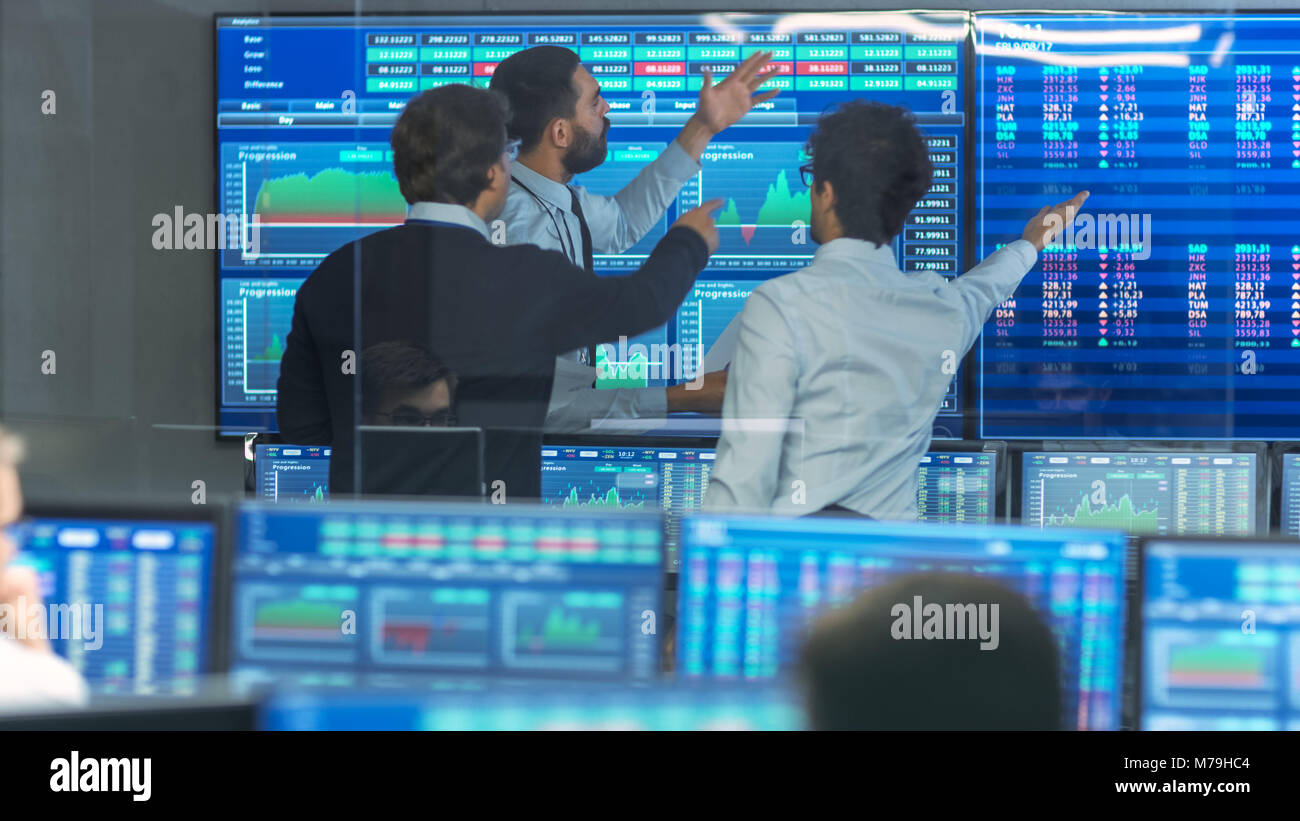 Three Experienced Stock Traders Talking Business, Consulting Documents ...