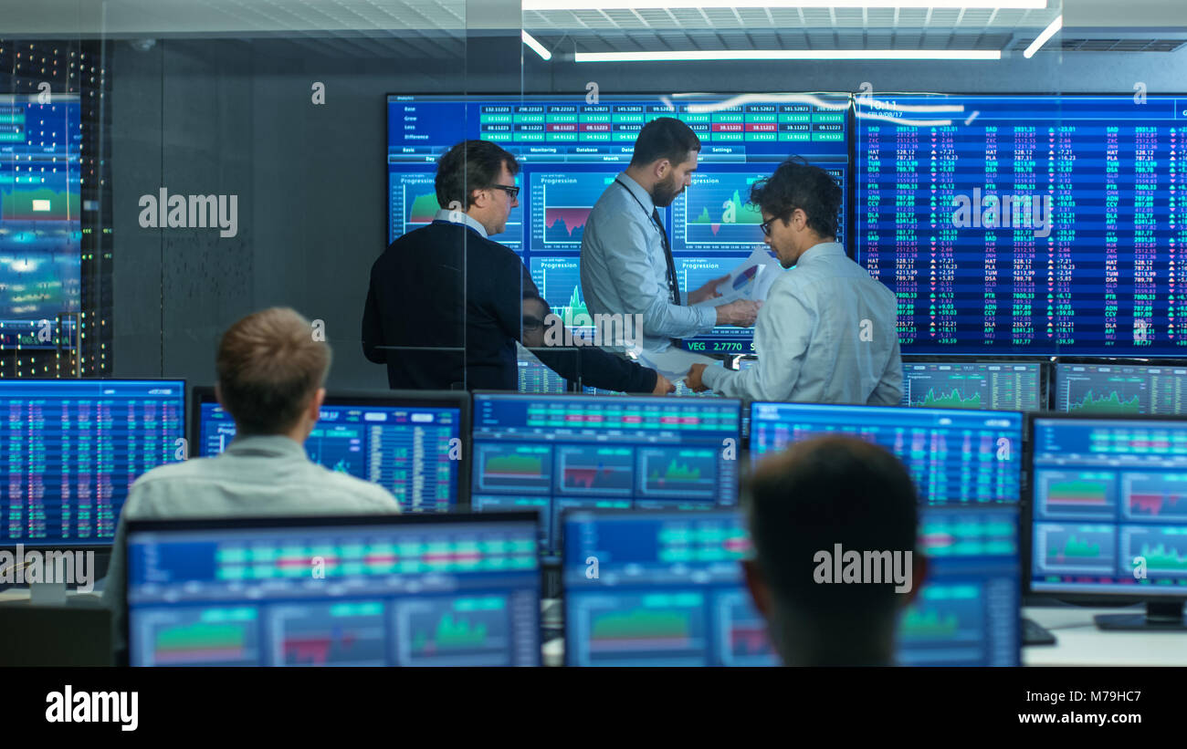 Three Experienced Stock Traders Talking Business, Consulting Documents ...