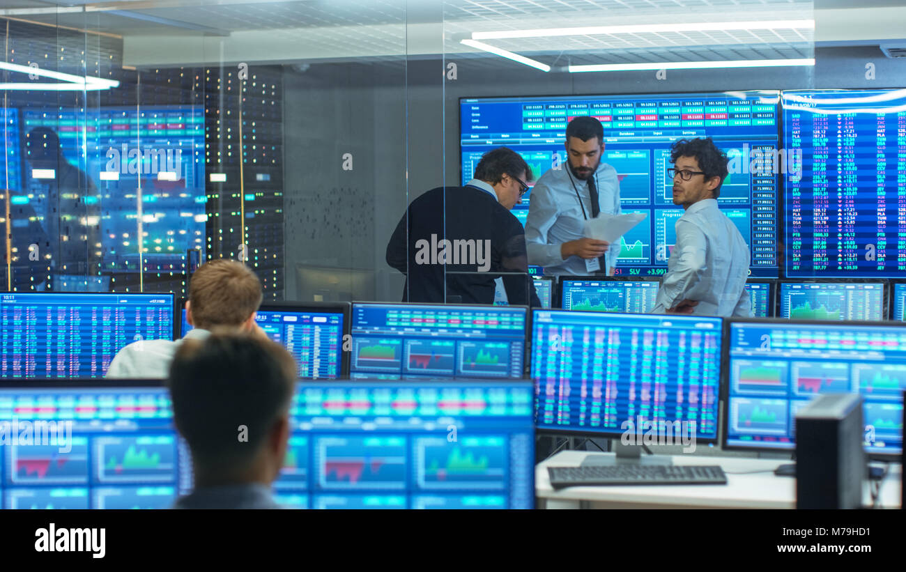 Three Experienced Stock Traders Talking Business, Consulting Documents ...