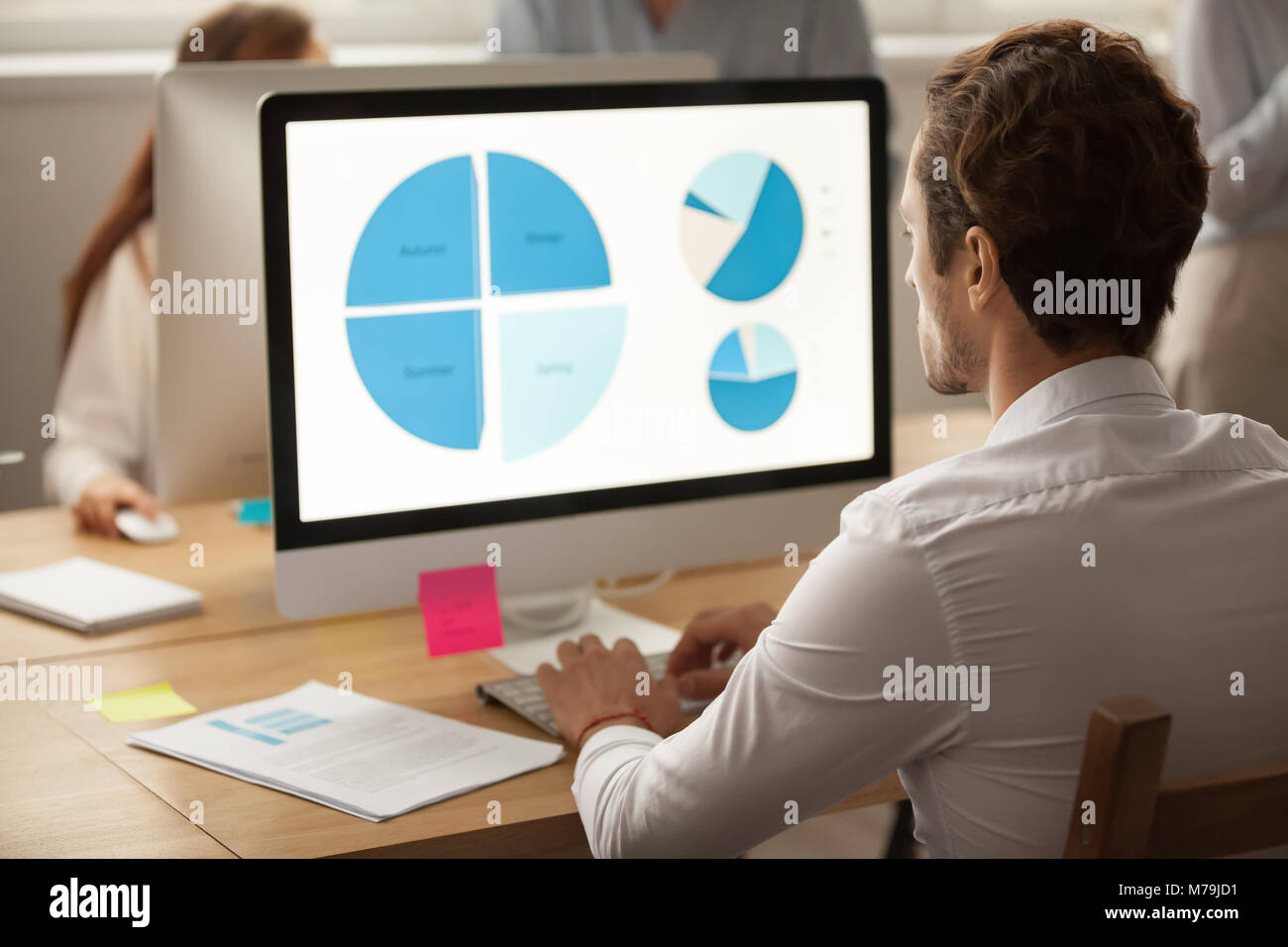 Focused businessman working on statistics report using computer Stock ...