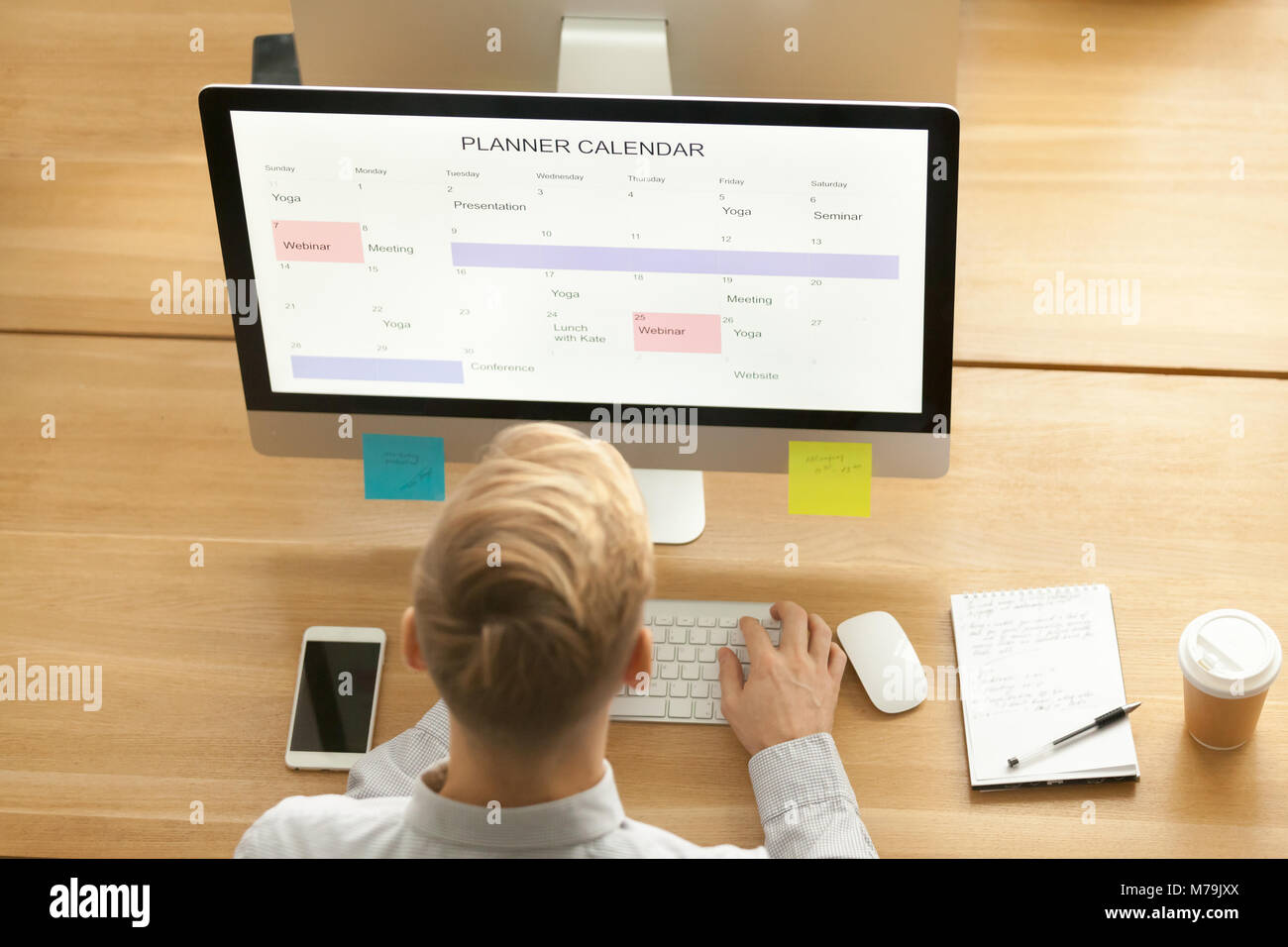 Businessman using planner application on computer in office, top Stock ...