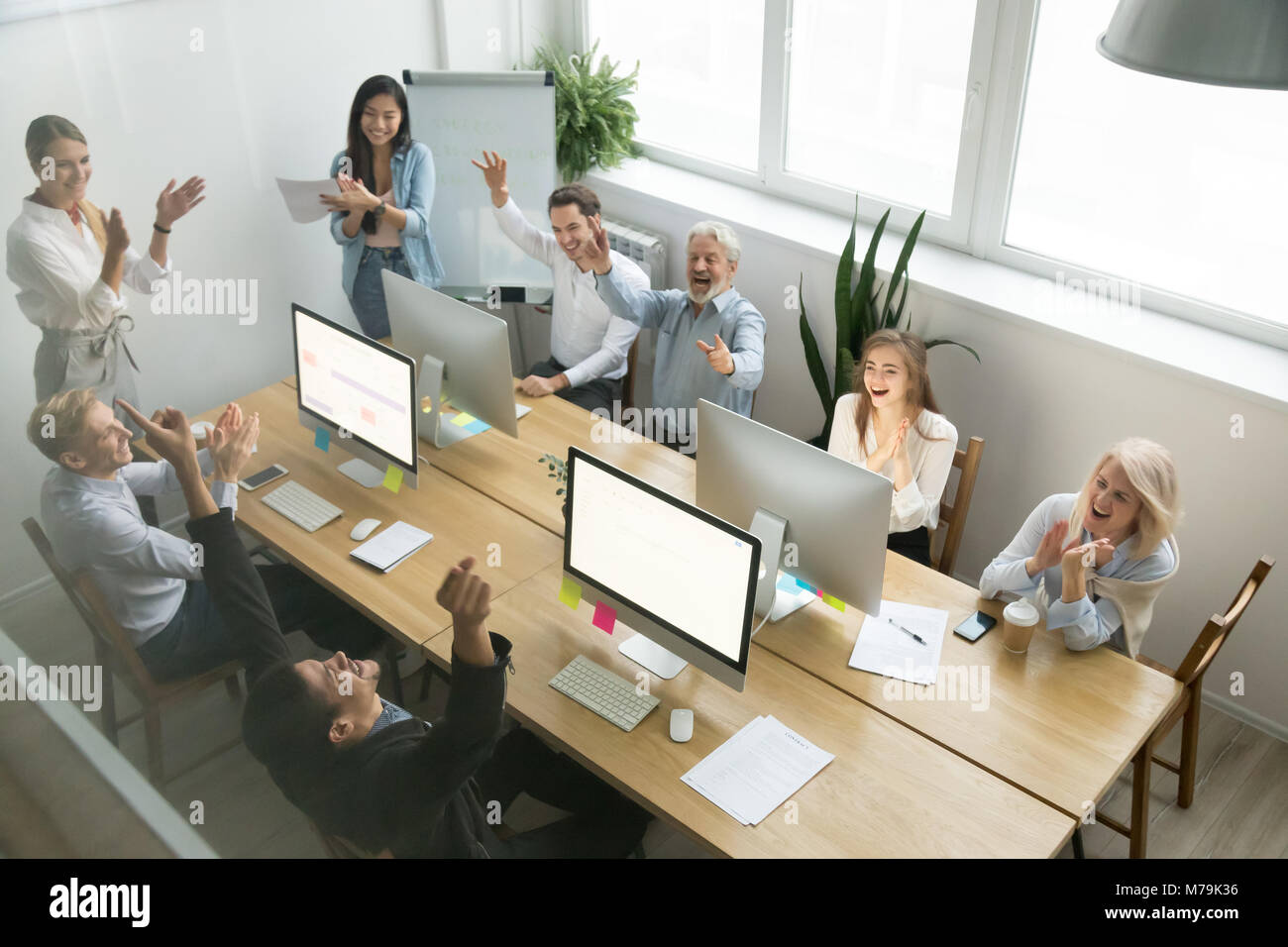 Excited diverse team congratulating black colleague with achieve Stock ...