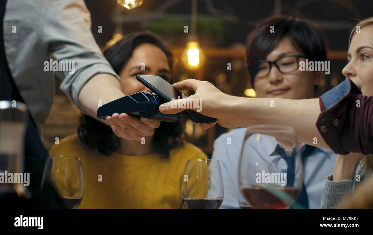 In the Bar Waiter Holds Credit Card Payment Machine and and Man Pays ...