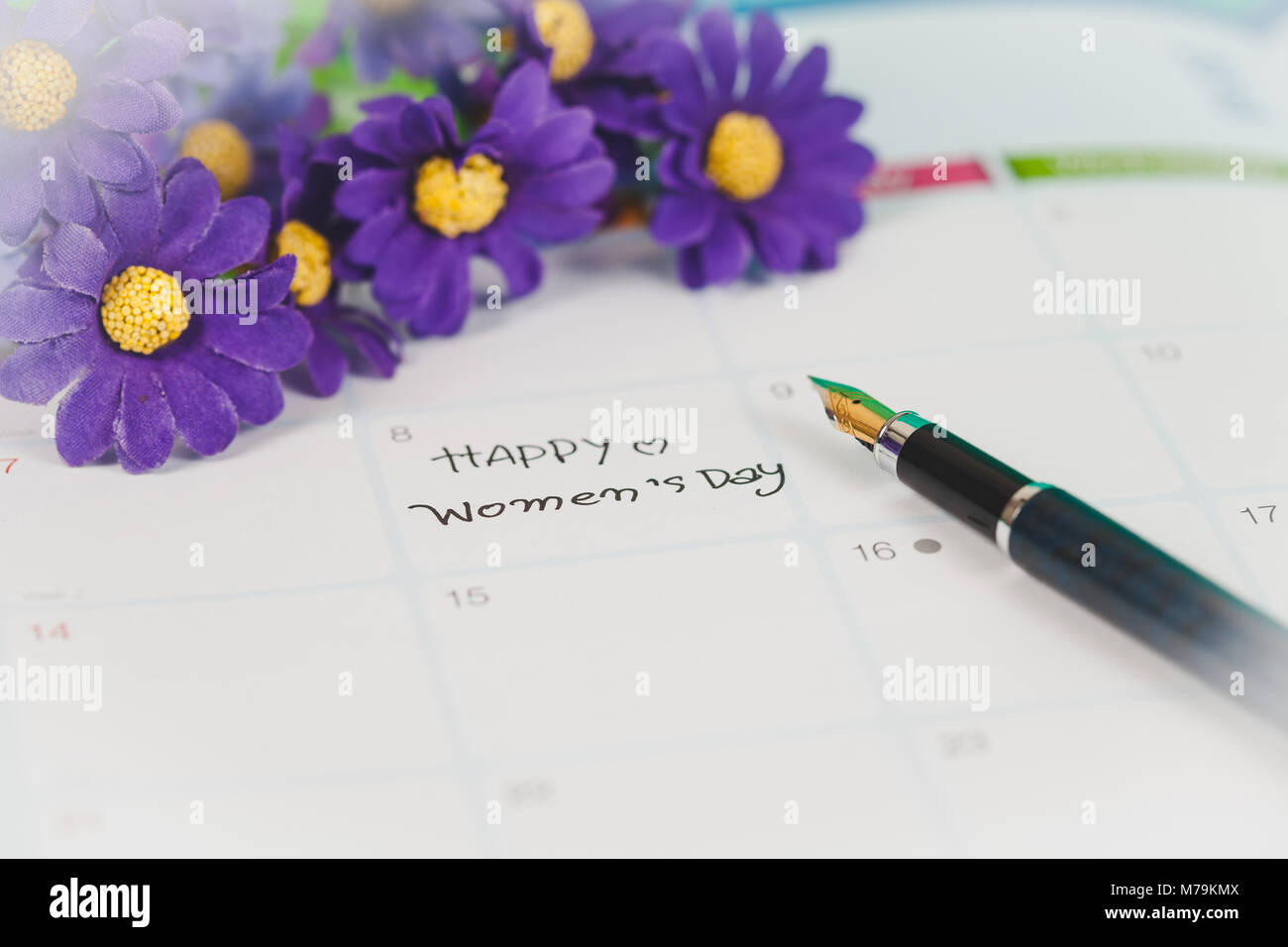 Happy women's day note on calendar book Stock Photo - Alamy