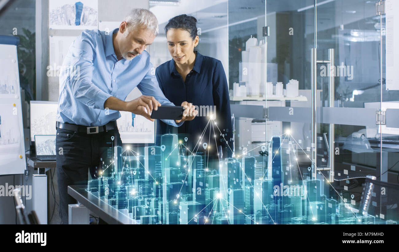 Male and Female Architects Work with Holographic Augmented Reality 3D ...