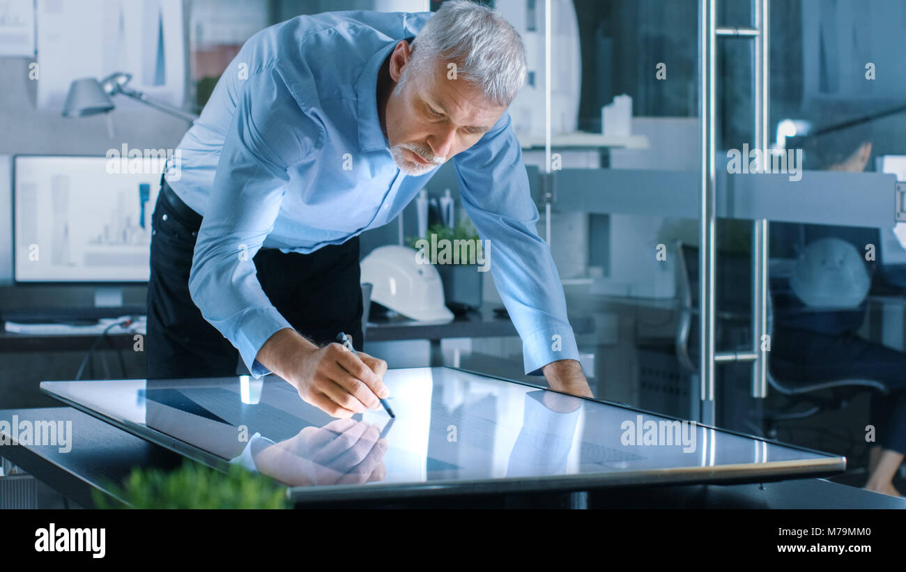 Senior Architectural Engineer Draws Building Concept on a Graphics ...