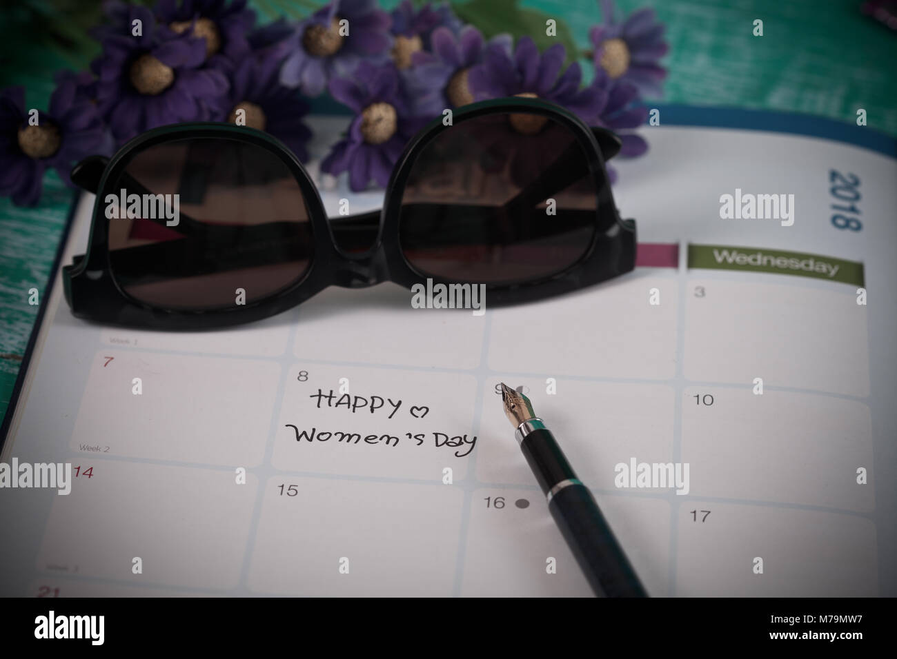 Happy women's day note on calendar book Stock Photo - Alamy