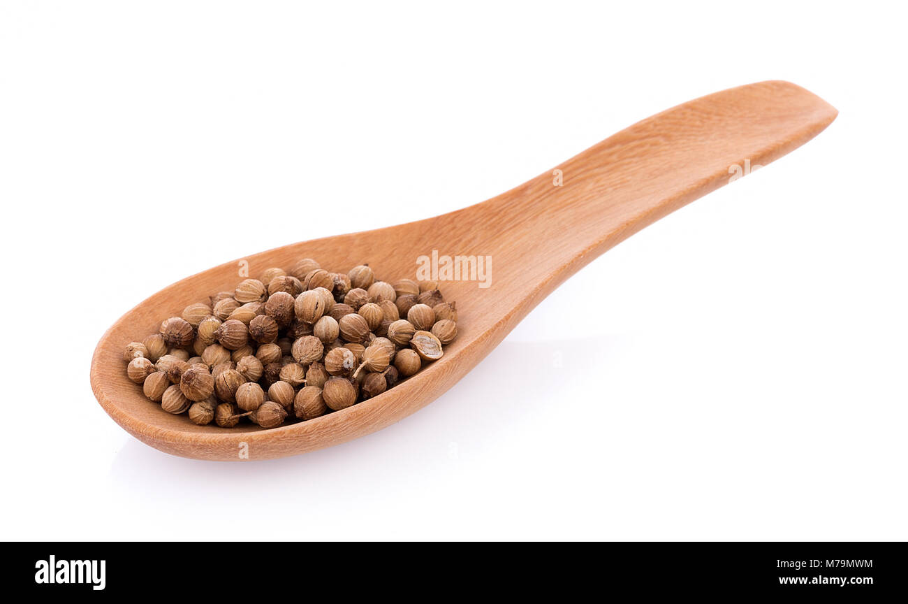 coriander seeds in spoon wooden on white background Stock Photo - Alamy