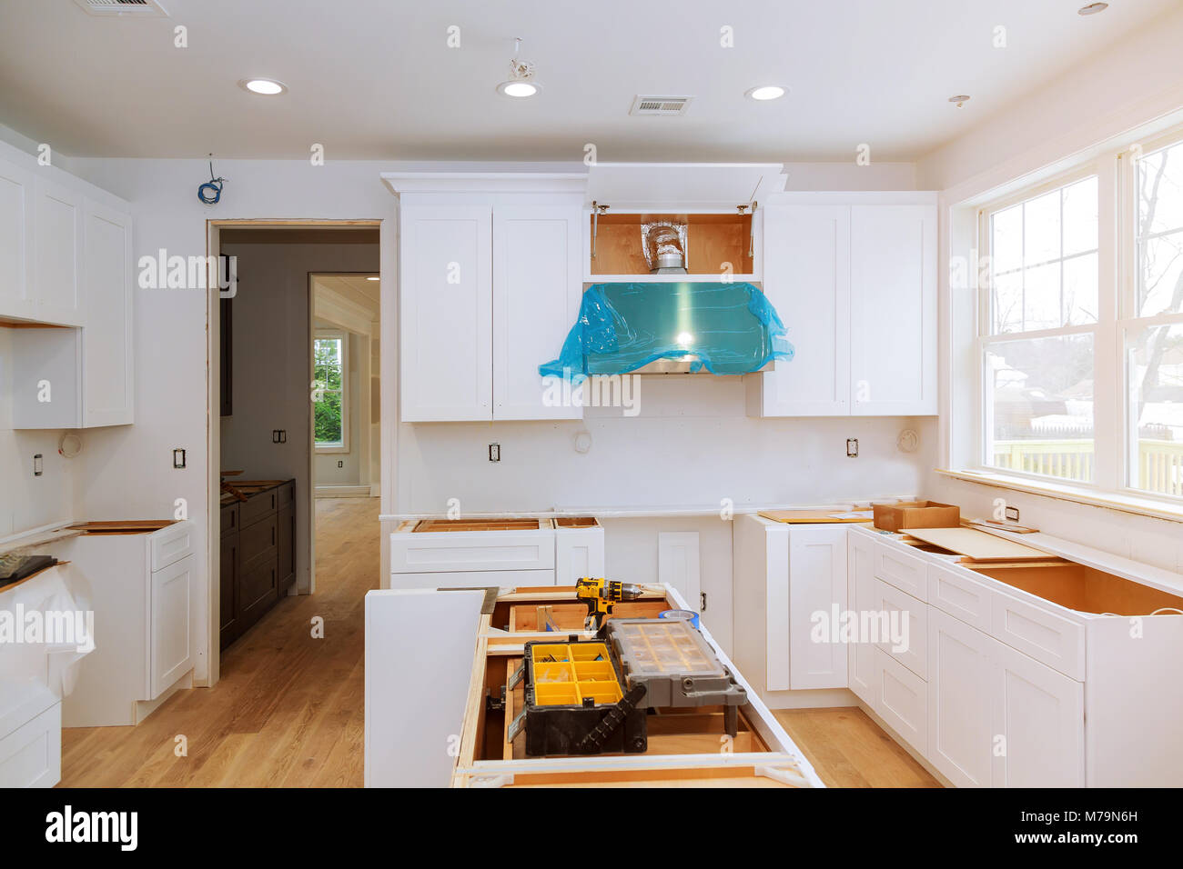 Custom kitchen cabinets in various stages of installation base for ...