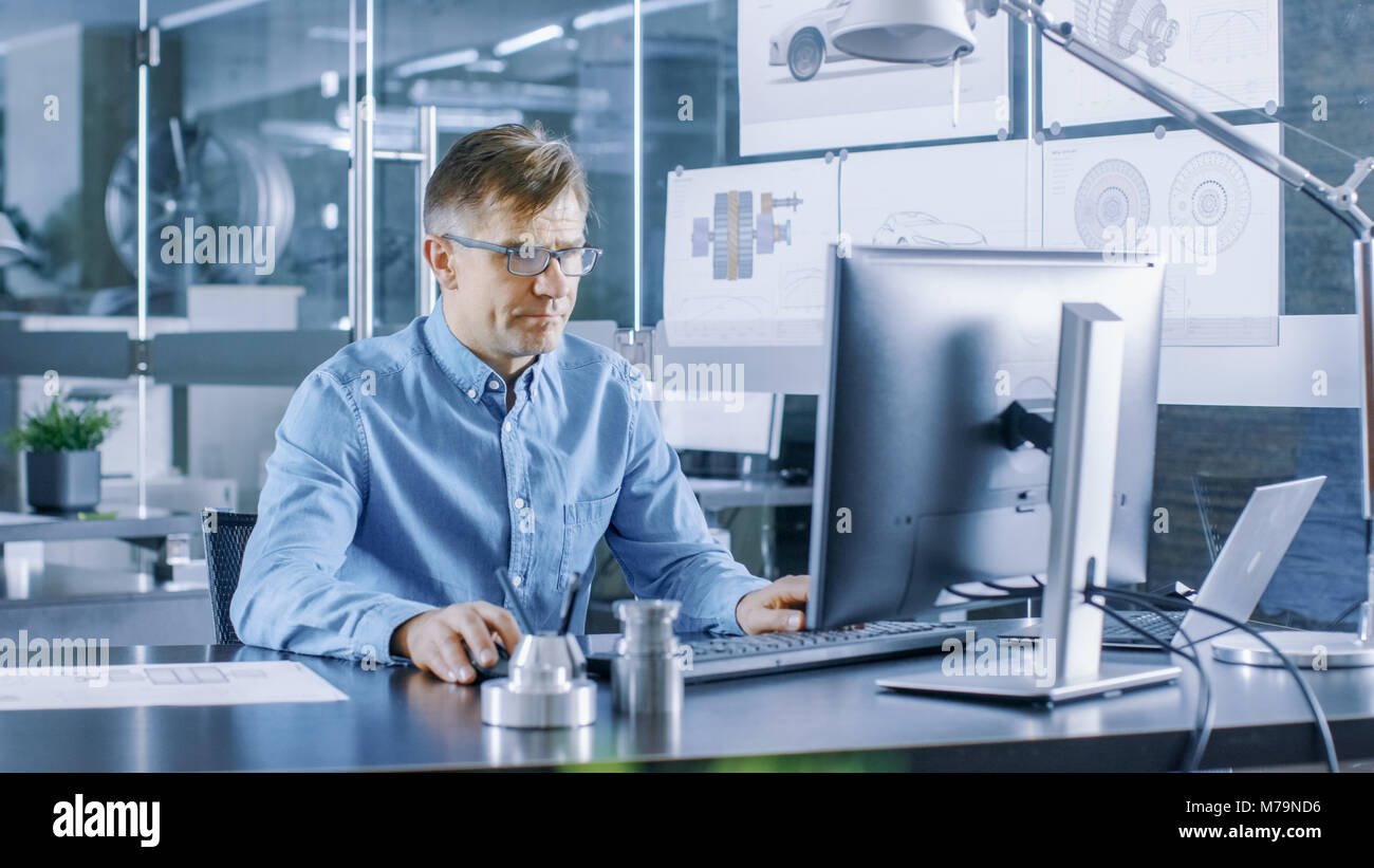 Experienced Industrial Engineer Working on Personal Computer in the ...