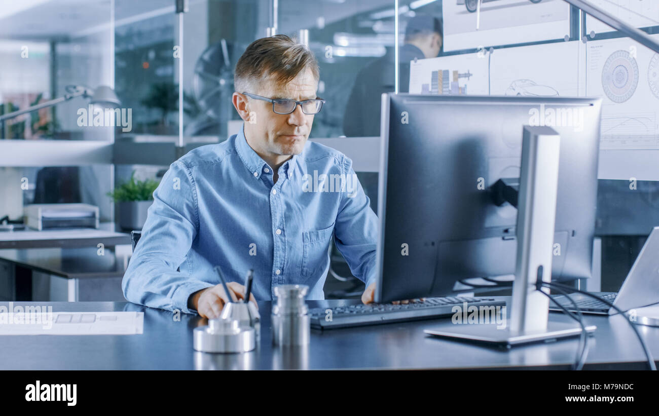 Experienced Industrial Engineer Working on Personal Computer in the ...