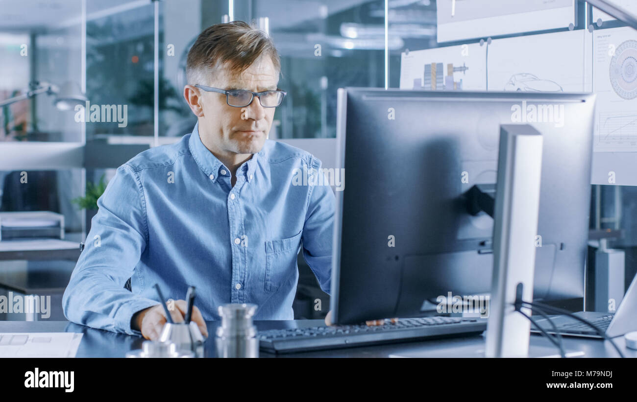 Experienced Industrial Engineer Working on Personal Computer in the ...