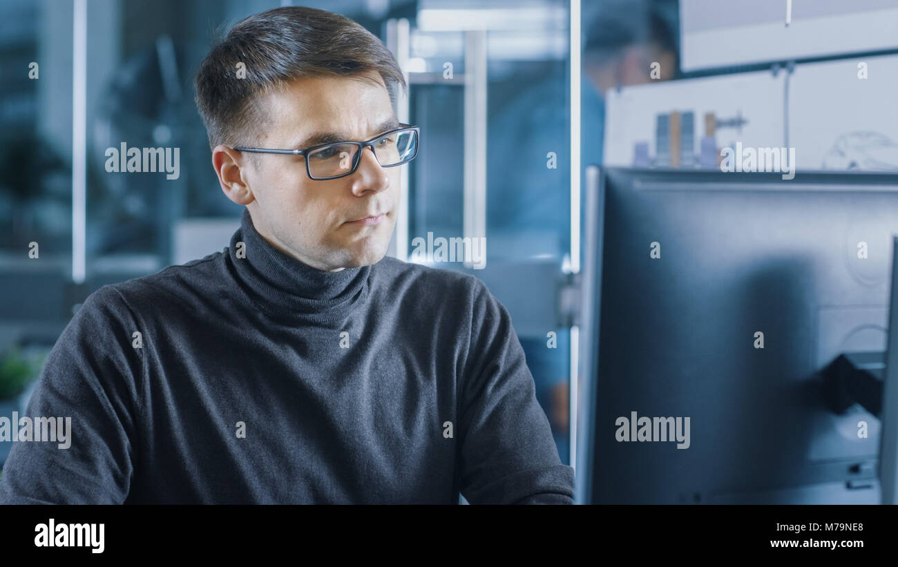 Young Male Industrial Engineer Works on a Personal Computer. Handsome ...