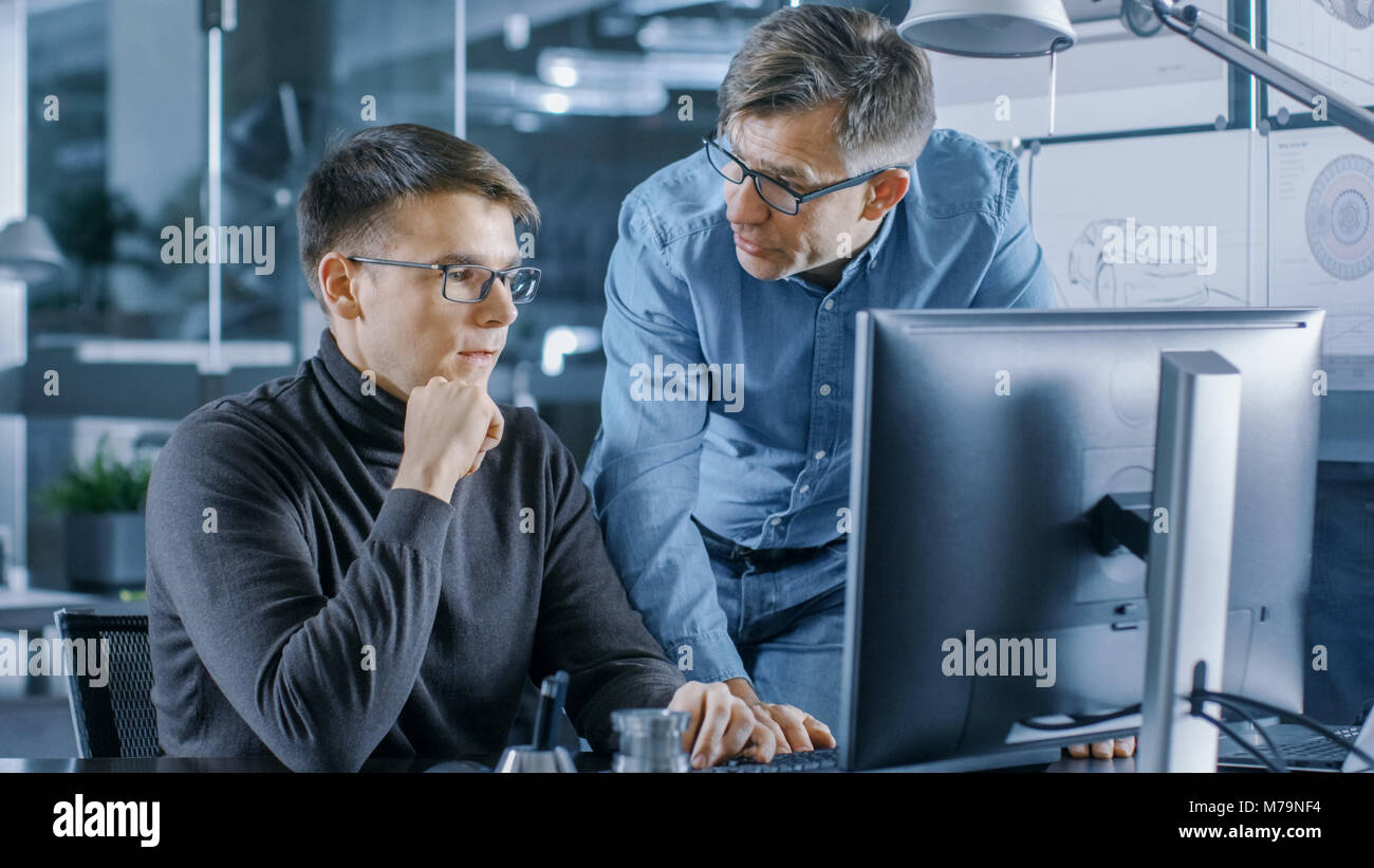 Experienced Senior Engineer Consults Young Designer about Project, They ...
