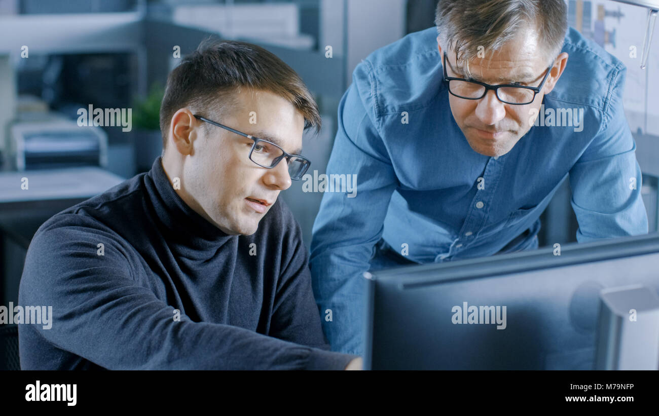 Experienced Senior Engineer Consults Young Designer about Project, They Have Discussion and Work ...