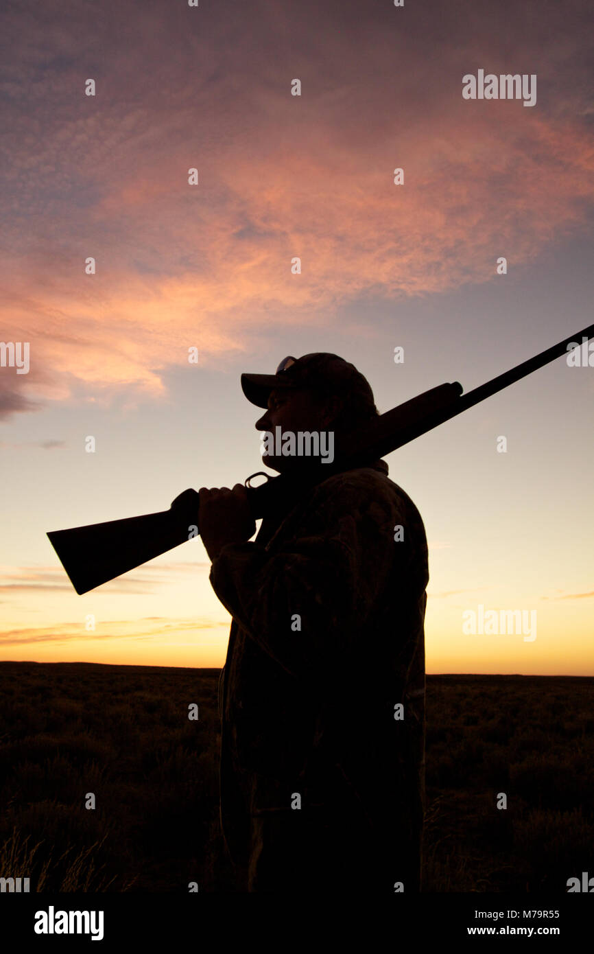 Hunter With Shotgun at Sunset Stock Photo - Alamy