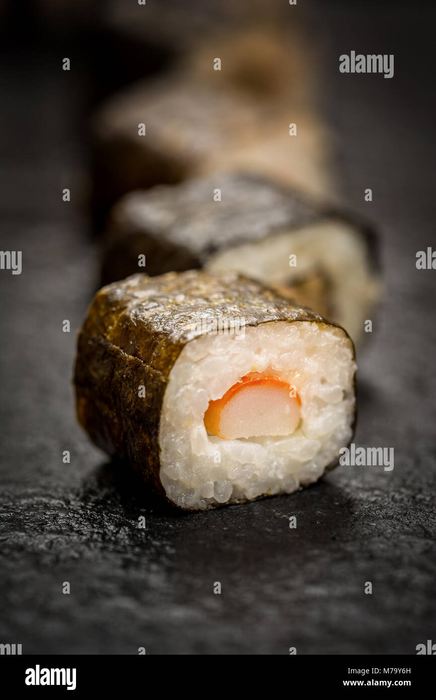 Traditional japanese sushi rolls hosomaki on stone desk Stock Photo - Alamy