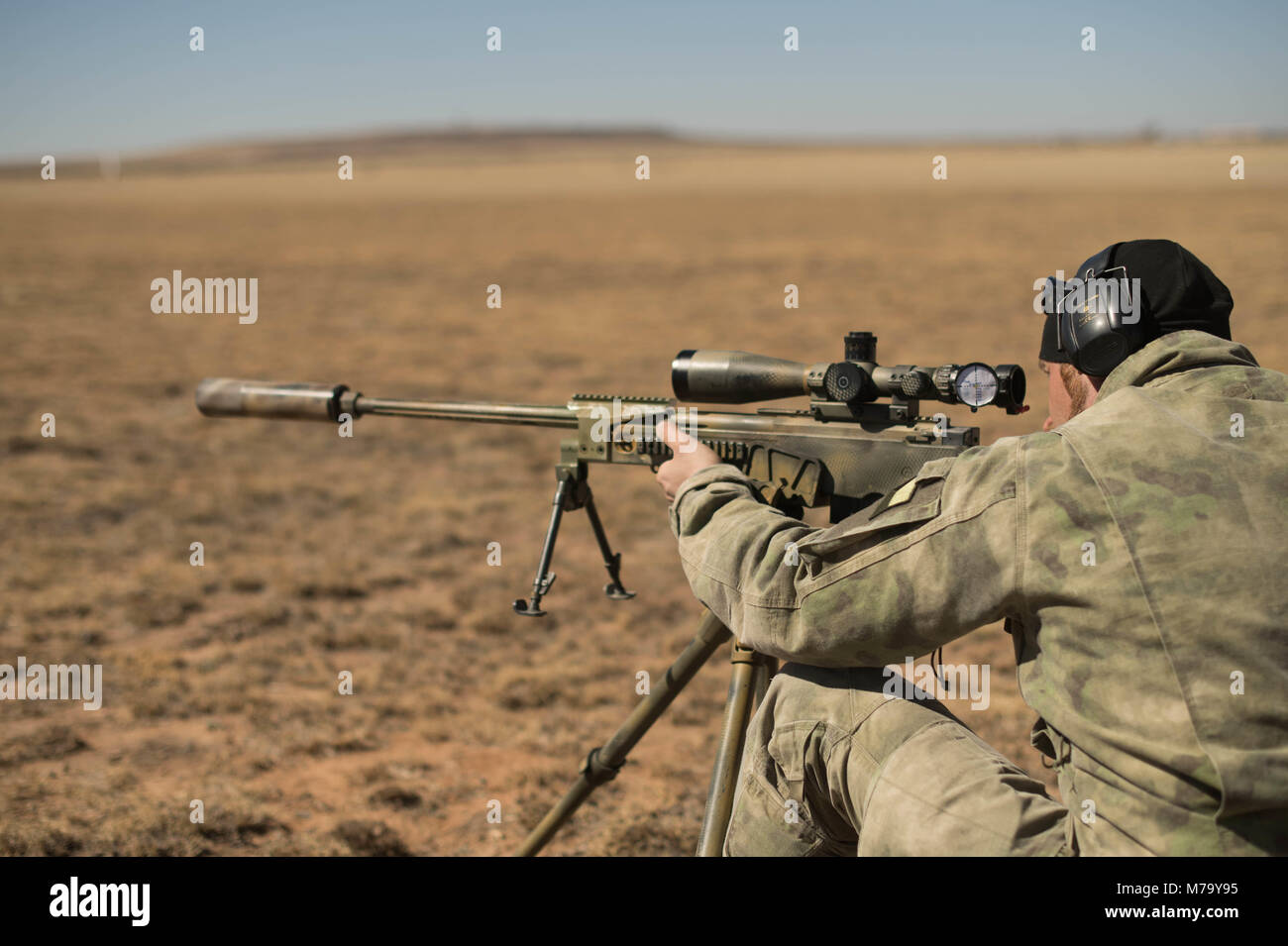 A NATO sniper trains on firing at long distances with sniper rifle ...