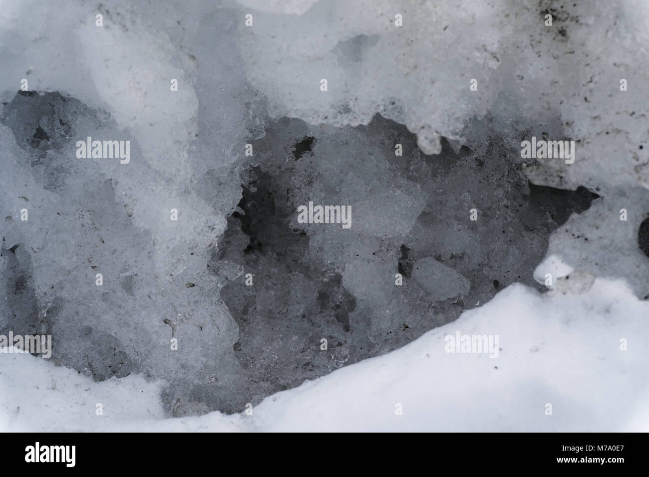 Snow Winter background, close-up of frosted ice lump on a snowing day ...