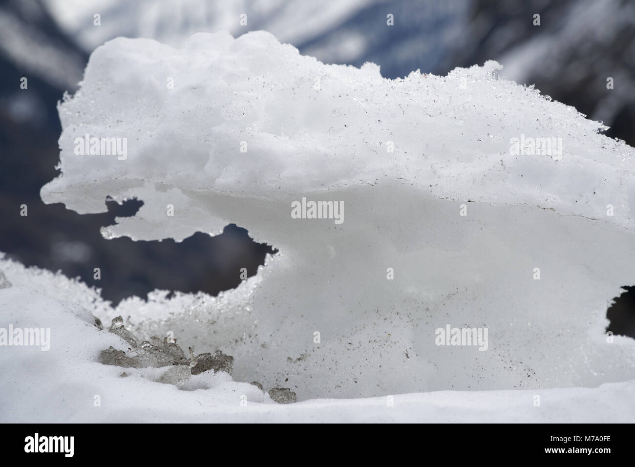 Snow Winter background, close-up of frosted ice lump on a snowing day ...