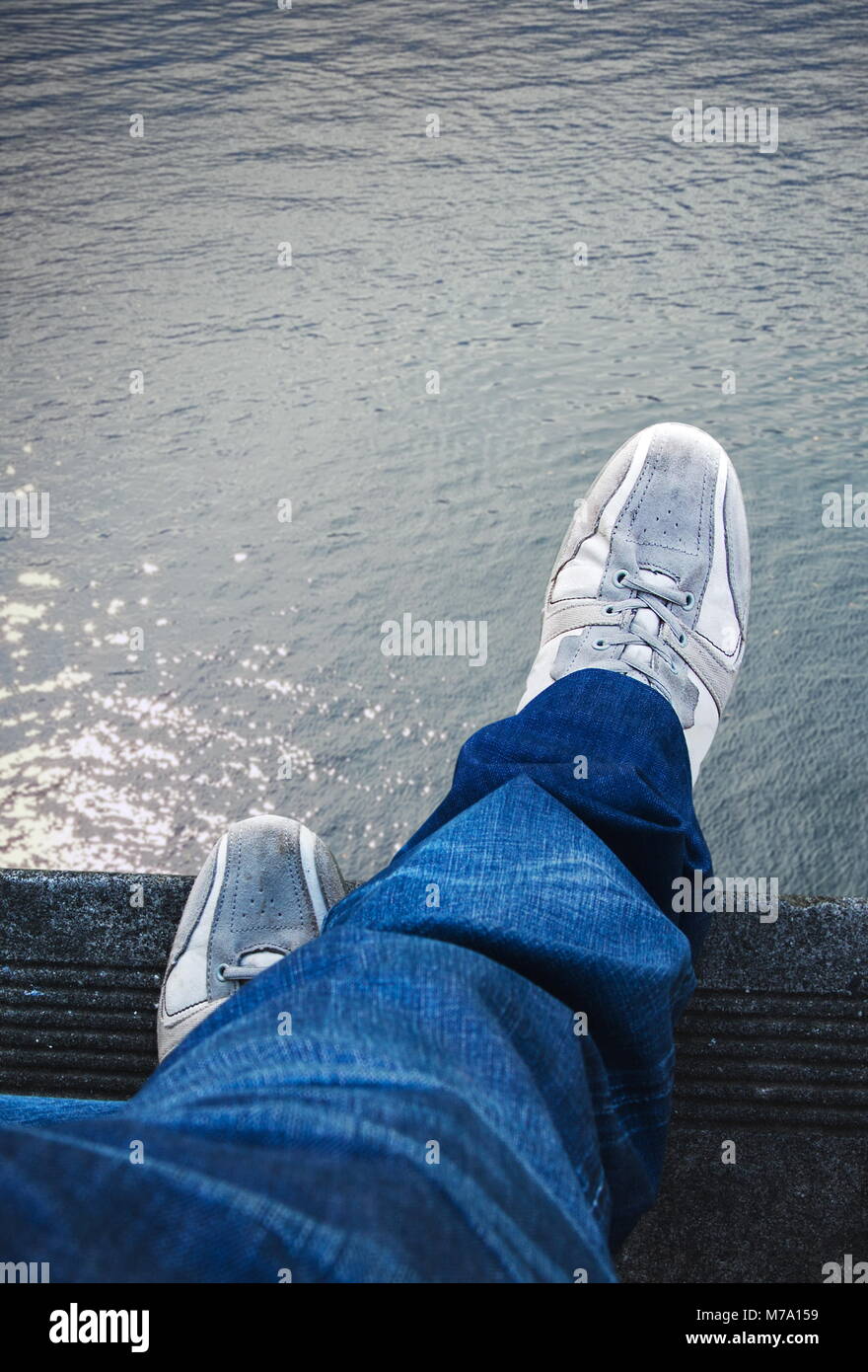 Man standing on the edge Stock Photo - Alamy
