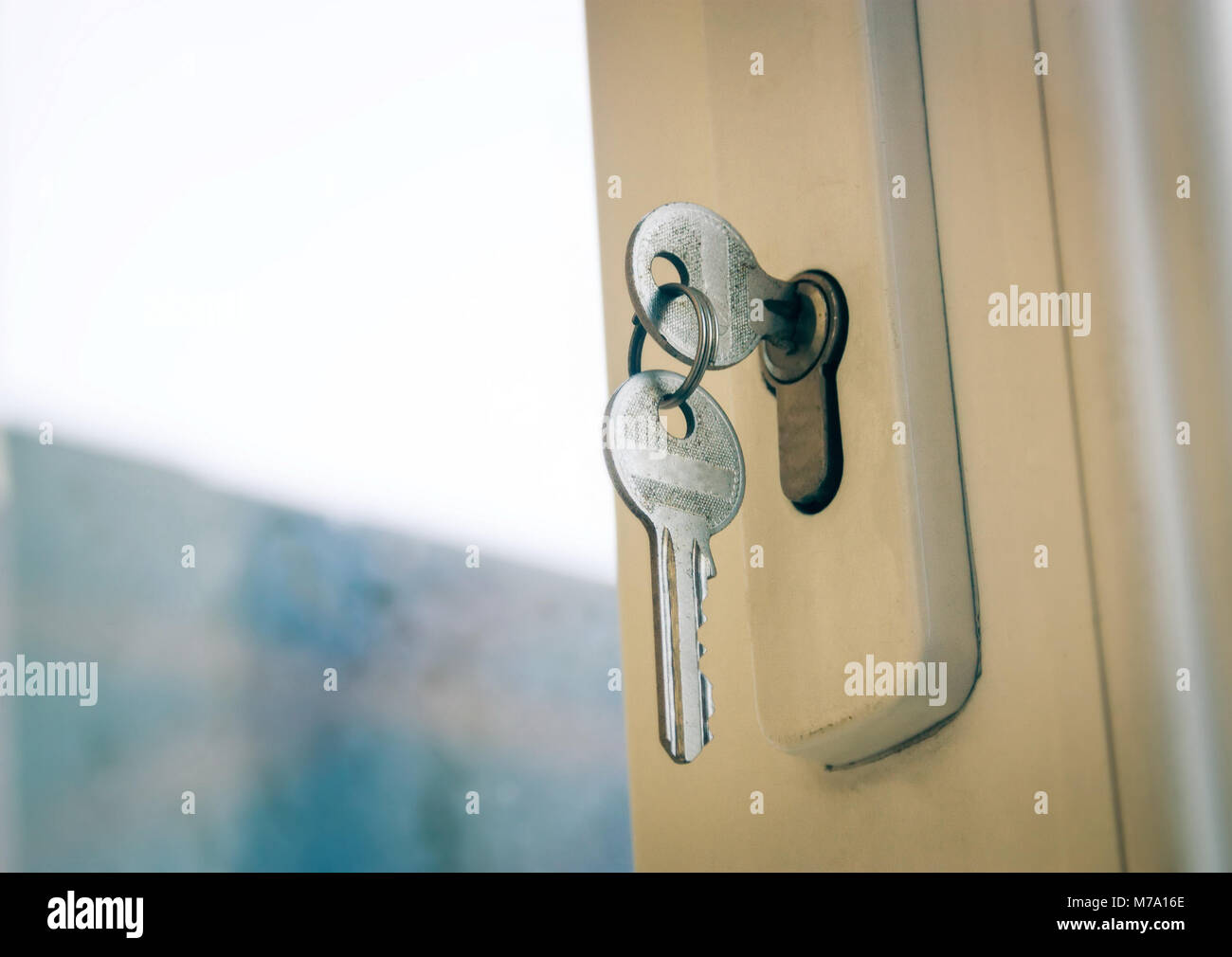 Metal keys in the home door Stock Photo - Alamy
