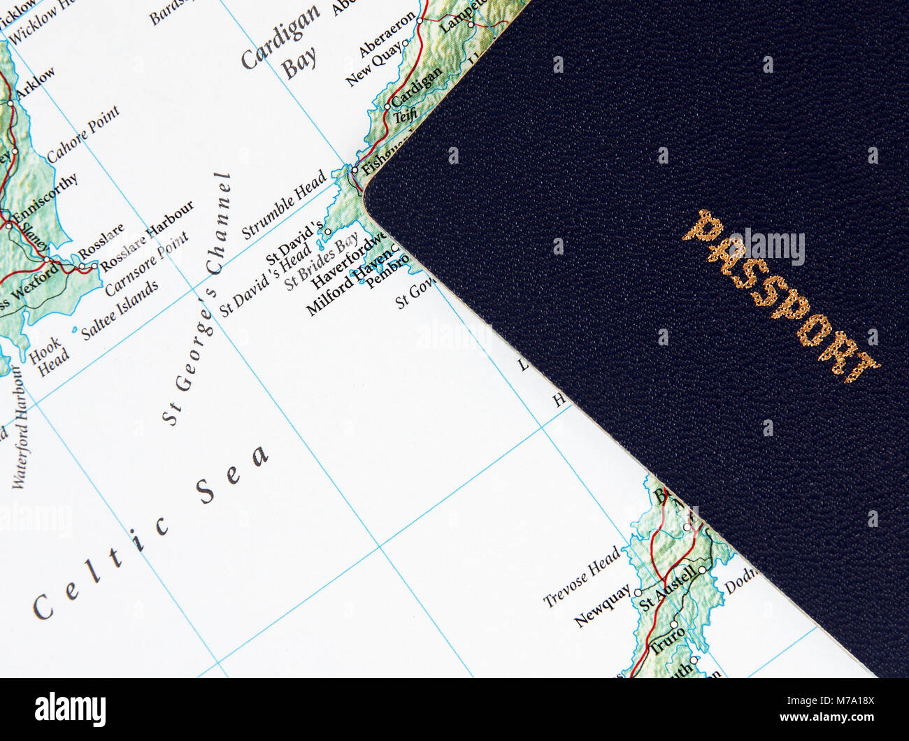 Passport on the open map Stock Photo - Alamy