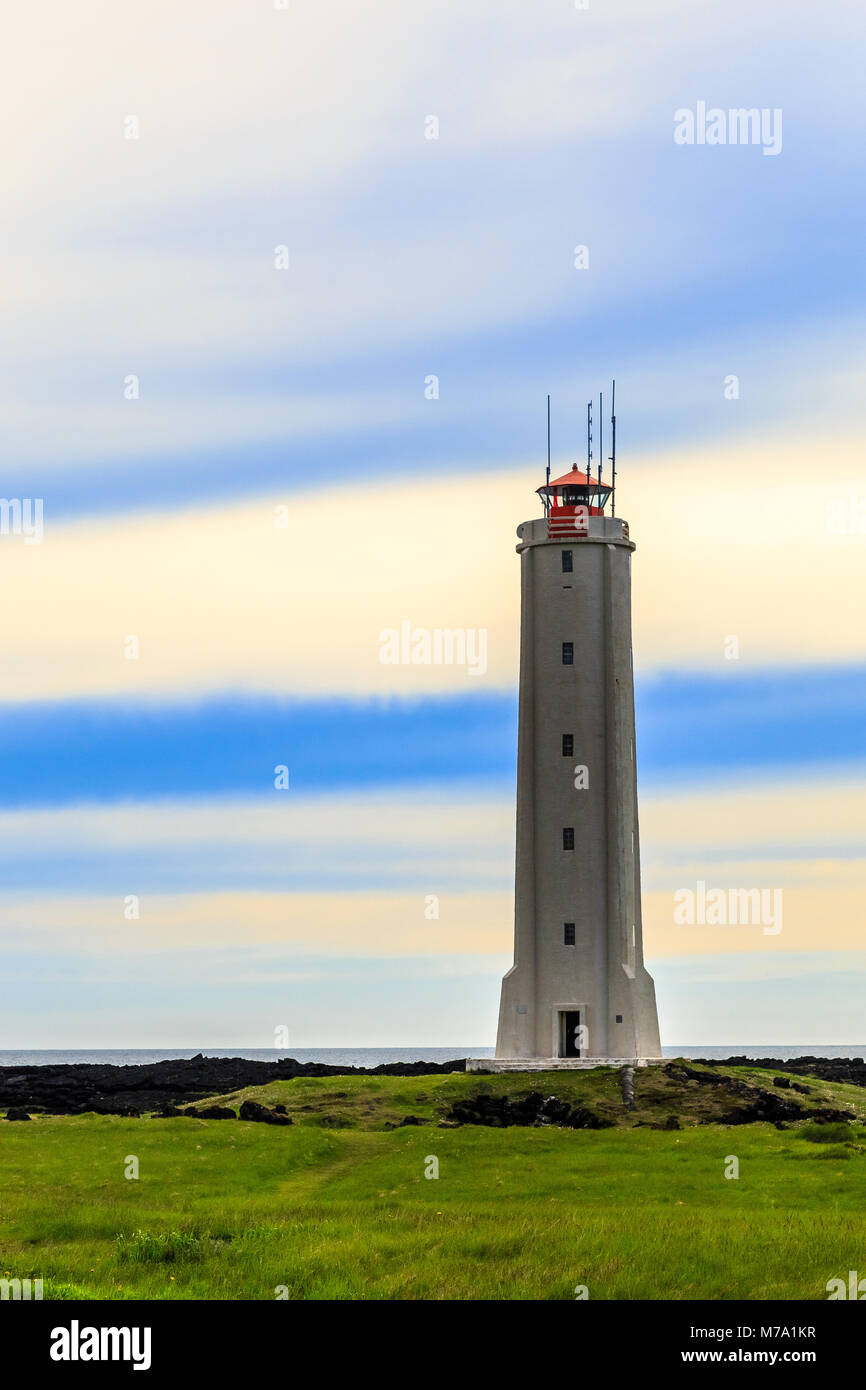 Malariff lighthouse tower standing on the seashore with striped sky in ...