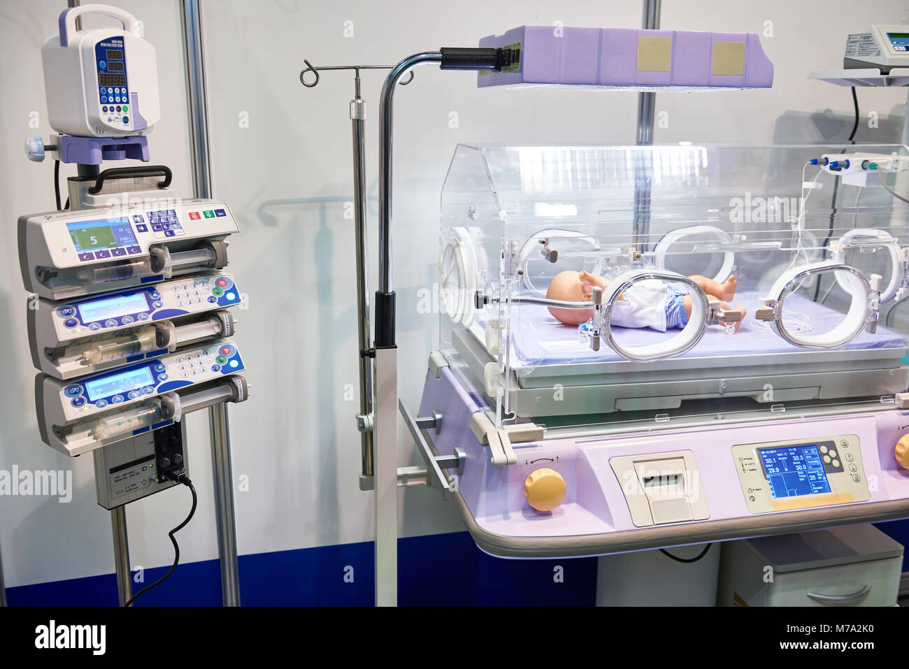 Incubator for newborns and syringe infusion pumps in clinic Stock Photo ...