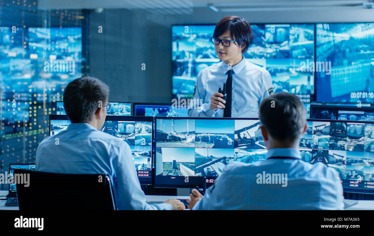 In the Security Control Room Chief Surveillance Officer Briefs Two of ...