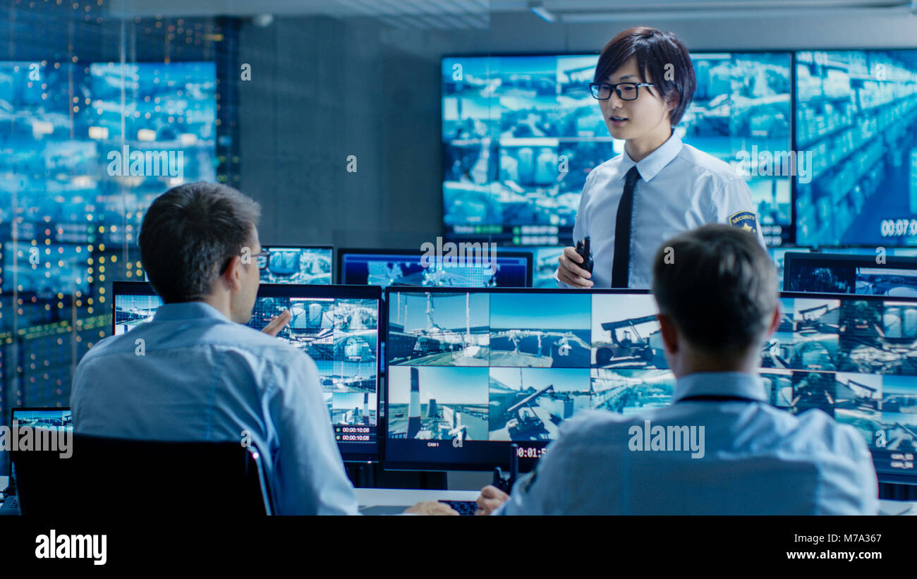 In the Security Control Room Chief Surveillance Officer Briefs Two of ...