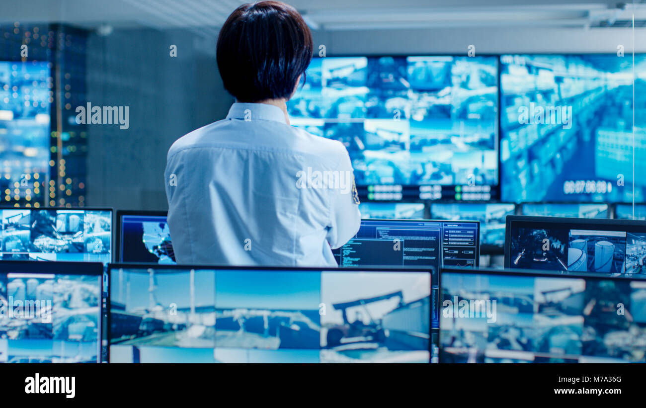 In the Security Control Room Officer Monitors Multiple Screens for ...