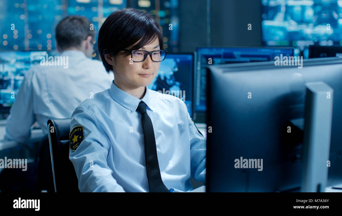 In the Security Command Center Officer at His Workstation Monitors ...