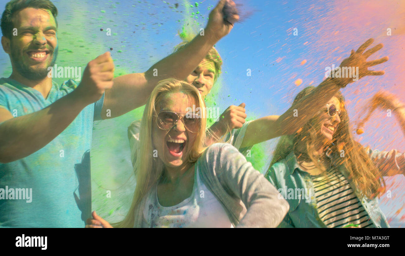 Multi-Ethnic Group of Young People Throw Colorful Powder in Celebration ...
