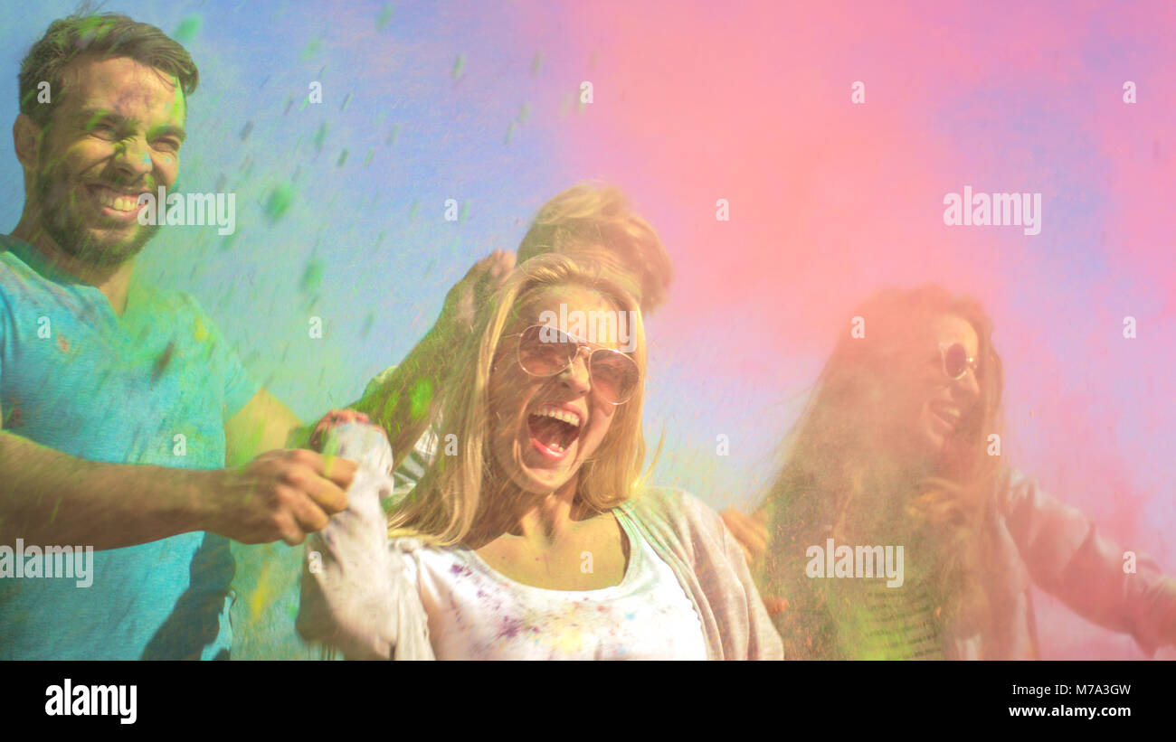 Multi-Ethnic Group of Young People Throw Colorful Powder in Celebration ...