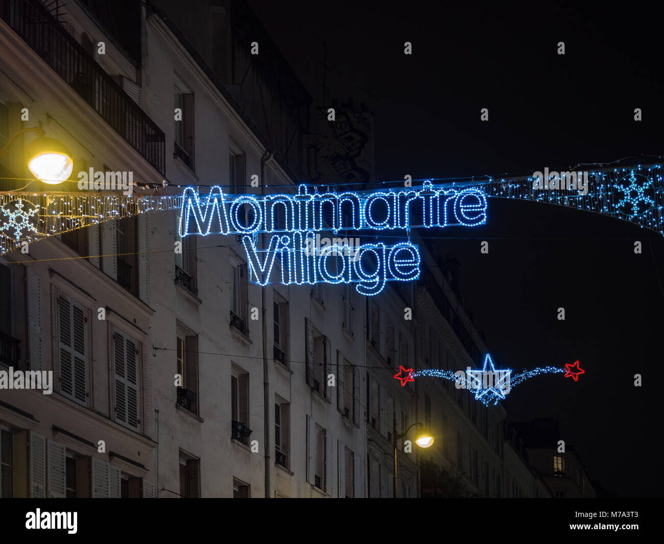 Illuminated sign with the words "Montmartre Village" placed at the ...