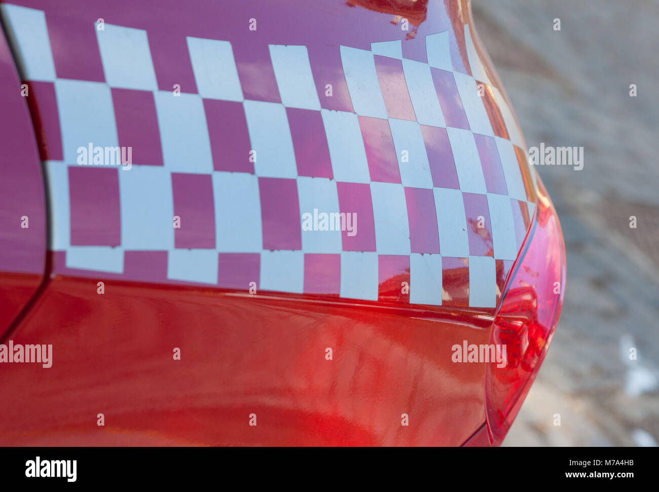 Rear light of a sports car with white and red checkered decoration ...