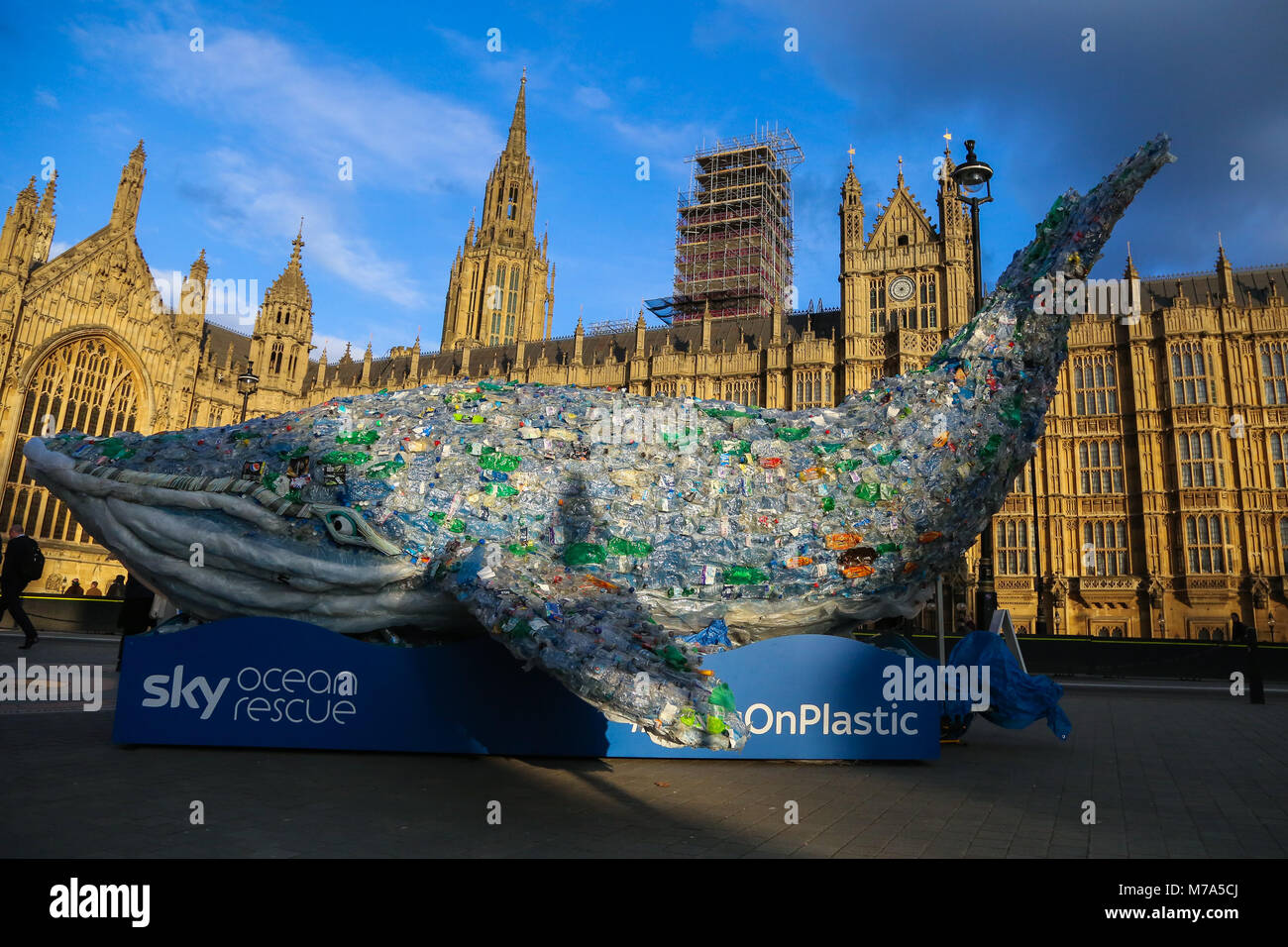 A large sculpture of a blue whale created out of various pieces of ...