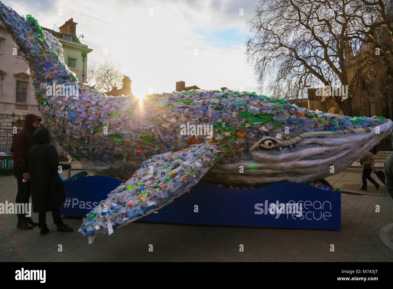 A large sculpture of a blue whale created out of various pieces of ...
