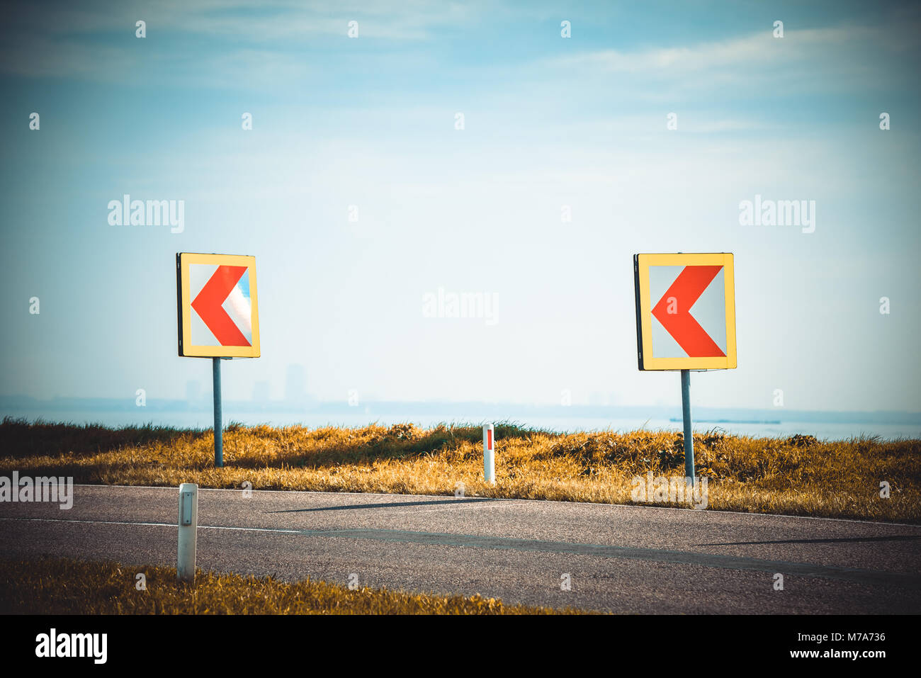 Road signs warning drivers about ahead dangerous curve Stock Photo - Alamy