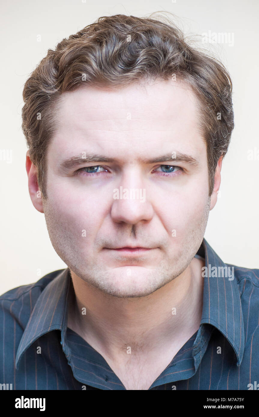 Portrait of young Caucasian Ethnicity frowning man looking questionably ...