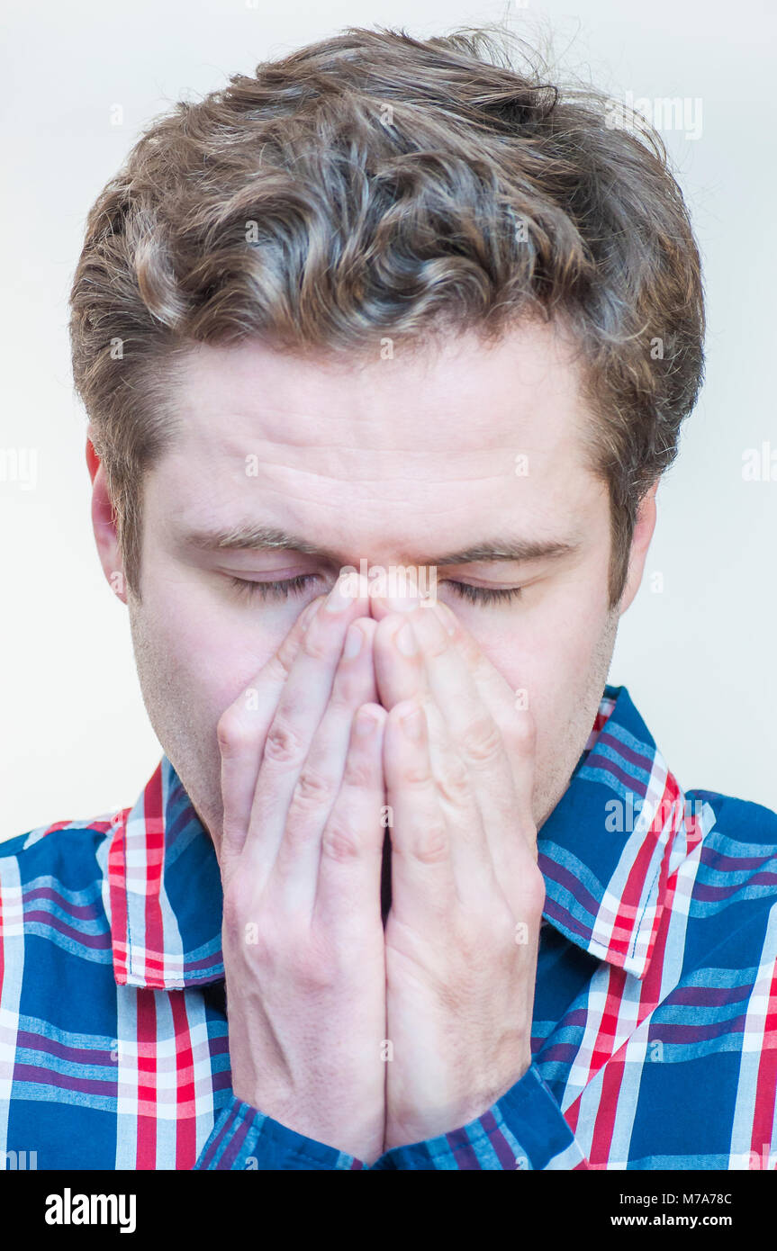 Portrait of young tranquil concentrated thinking man with eyes closed ...