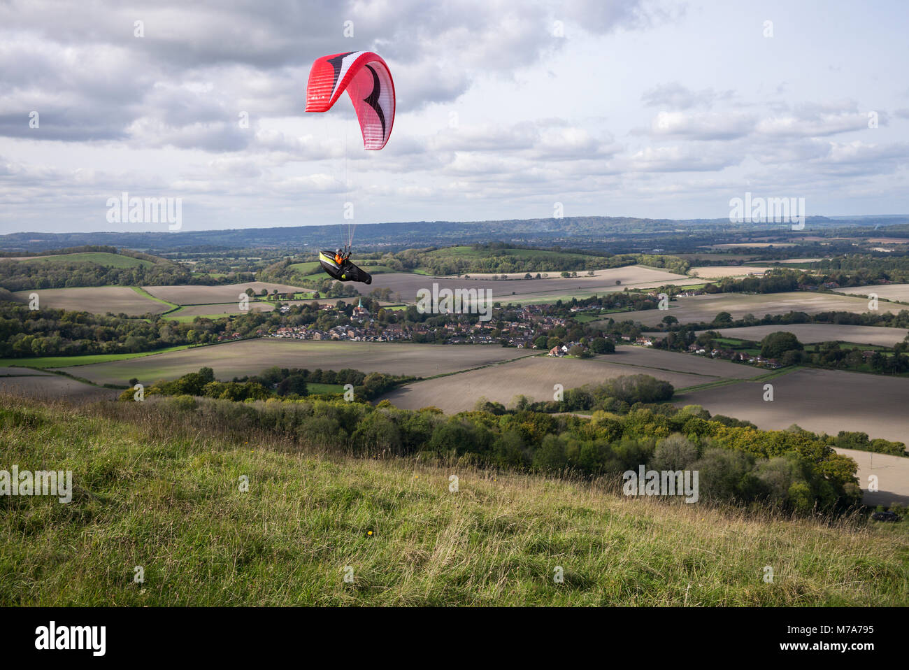 Paraglider flying above the north facing escarpment slope on Harting ...