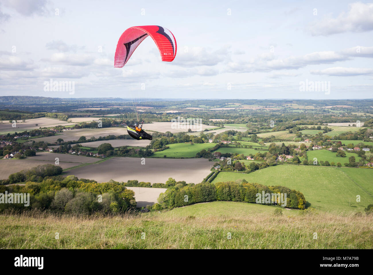 Paraglider flying above the north facing escarpment slope on Harting ...
