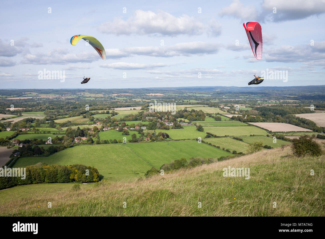 Paraglider flying above the north facing escarpment slope on Harting ...